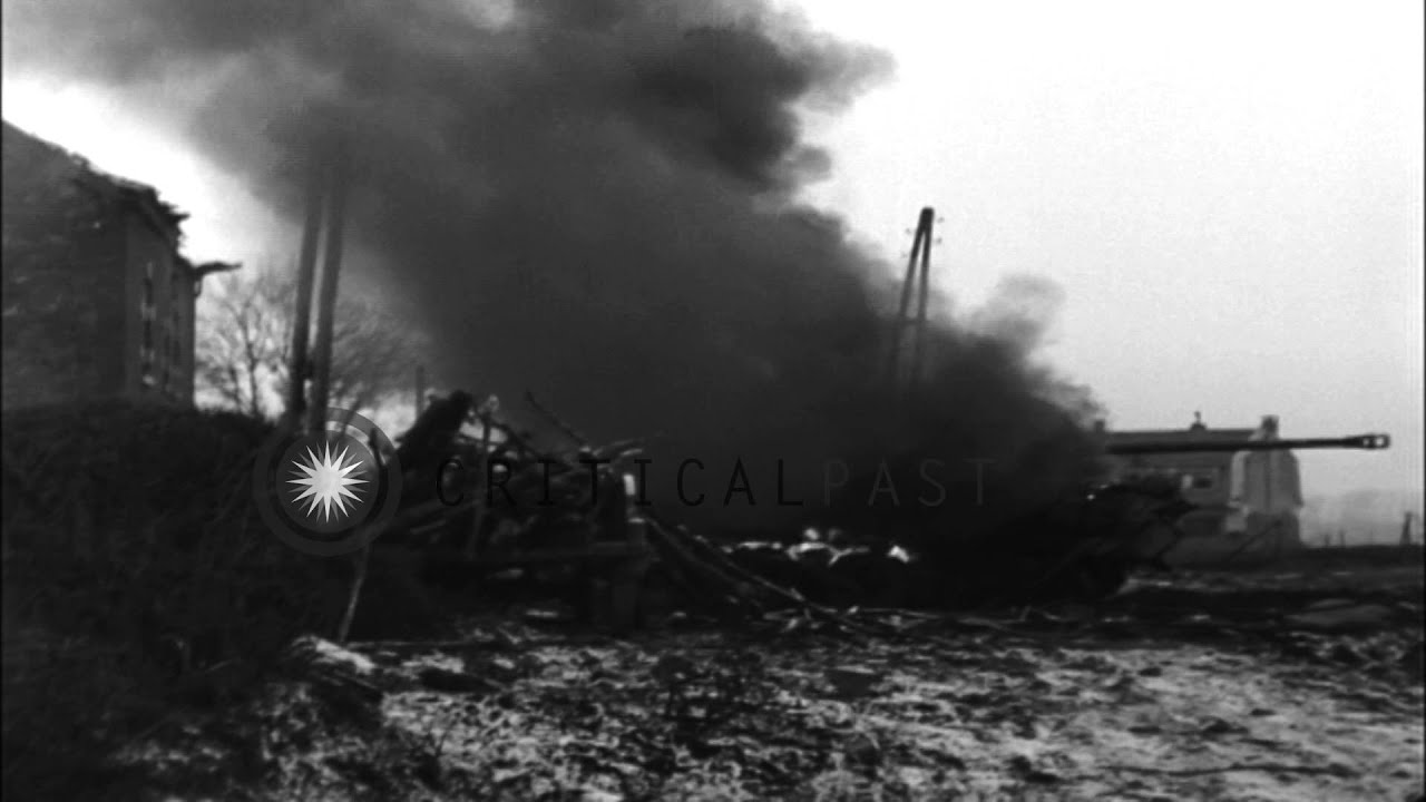 Smoke rise as German tanks burn and a damaged house in Hotton, Belgium ...