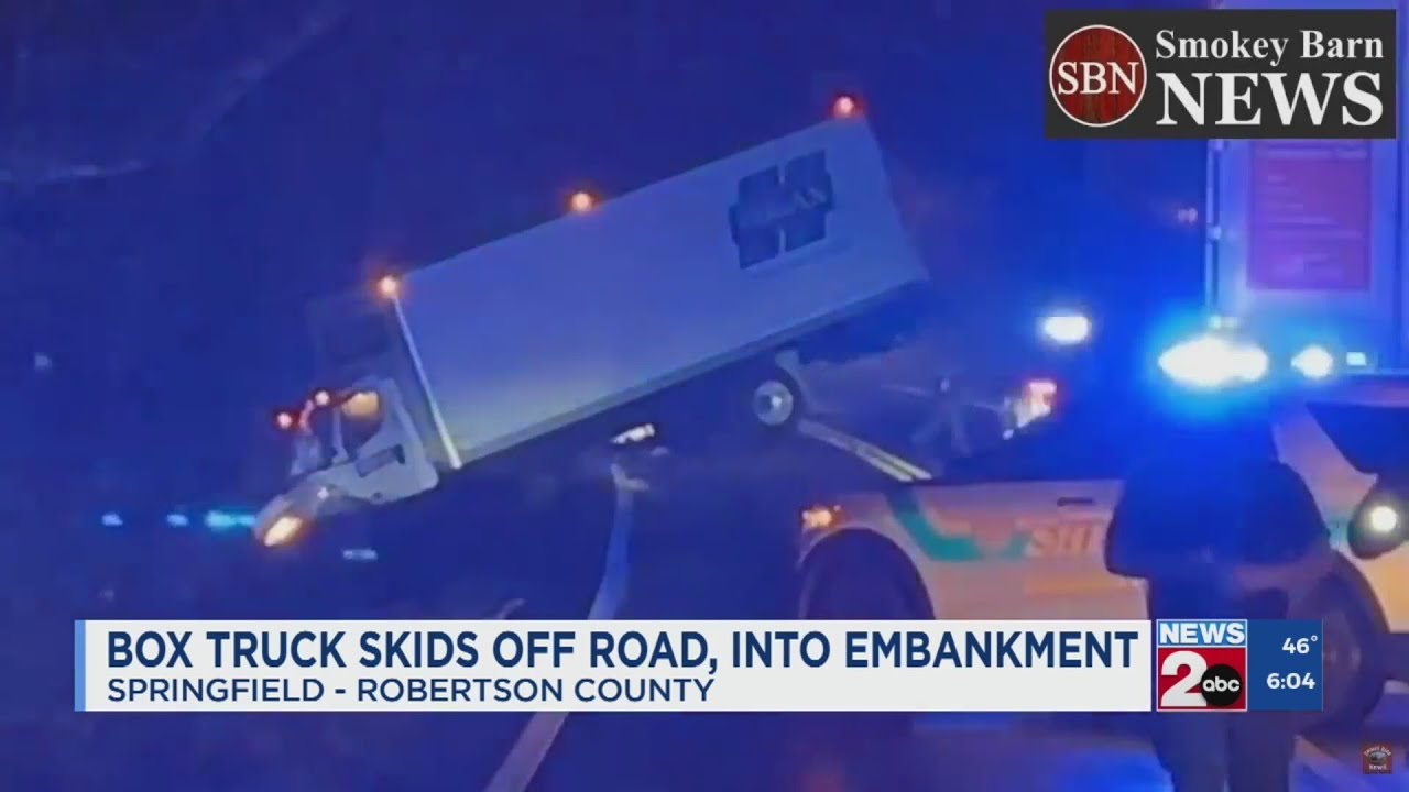 Box truck skids off road into embankment - YouTube