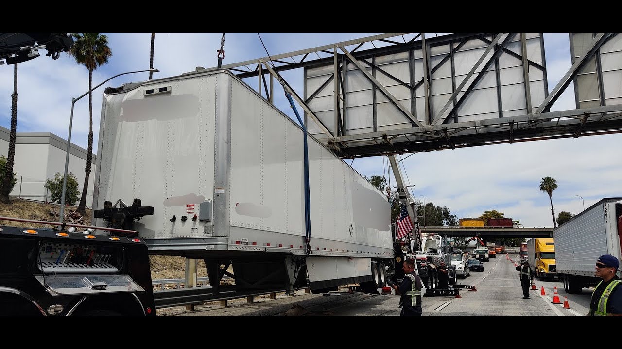 Up-righting a trailer under a freeway sign - YouTube