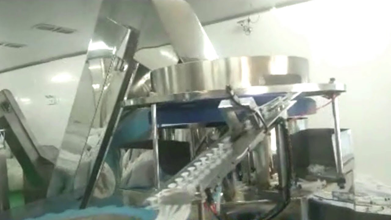 syringes loading feeding flow wrapping packaging equipment - YouTube