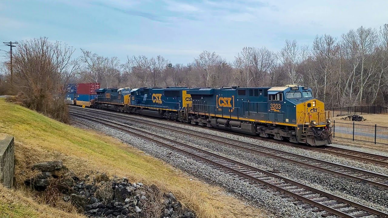 SD70MAC trails on short CSX intermodal train past old Caperton Station ...