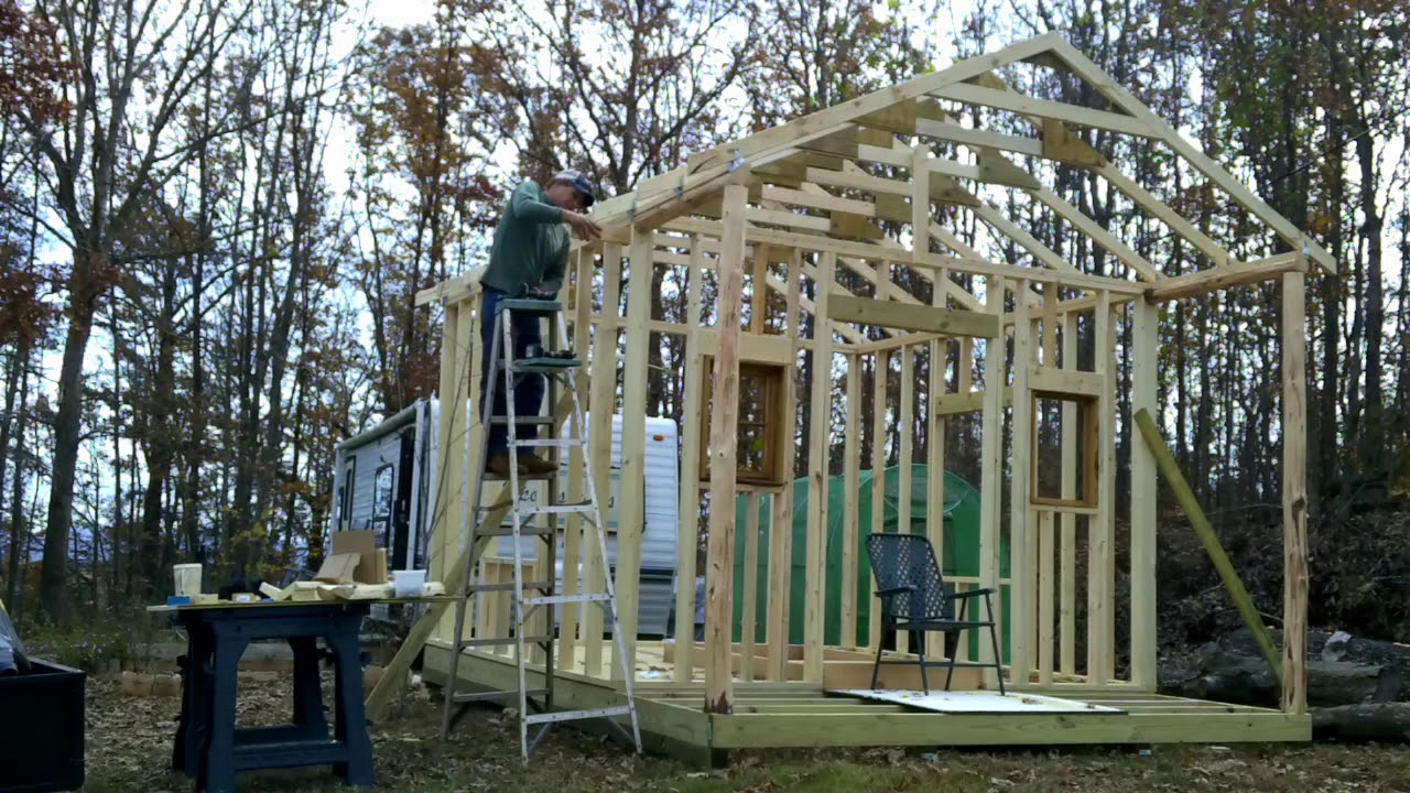 Installing the rafters on the rustic cabin build - YouTube