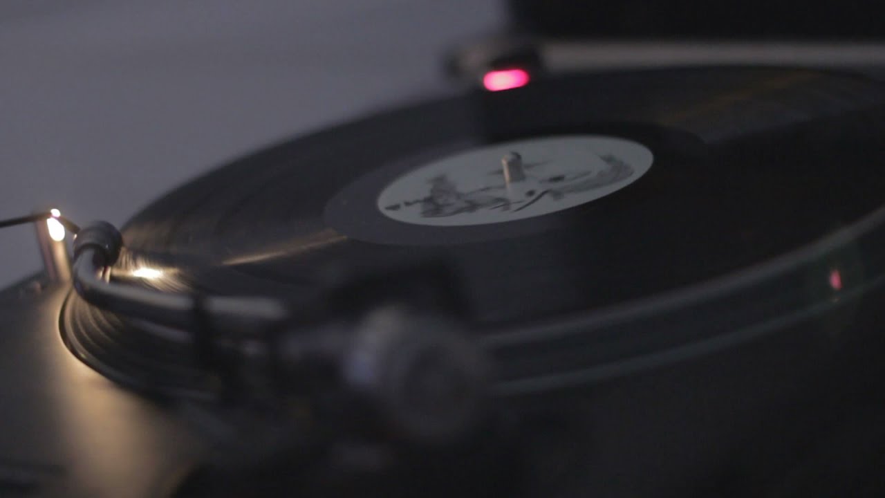 Hands of dj rotating vinyl record on turntable in nightclub. Stock ...