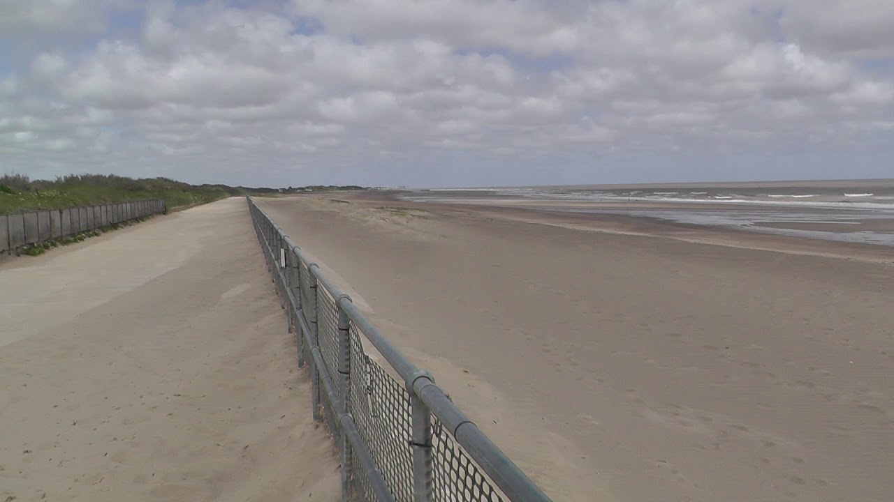 Walking on windy nice Chapel St Leonards beach sea front near Skegness ...