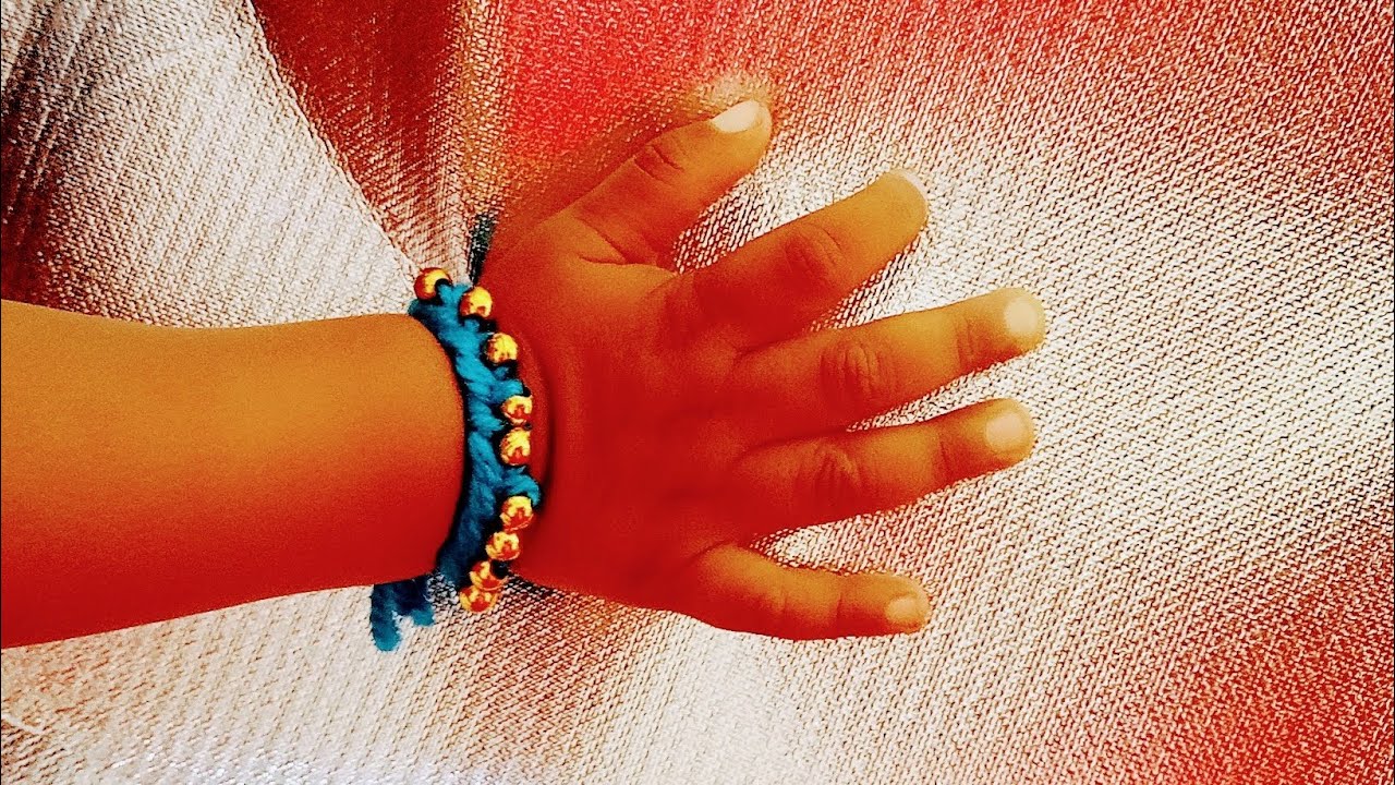 A beautiful breslet for kids 😍 with wool and golden pearl that is use ...