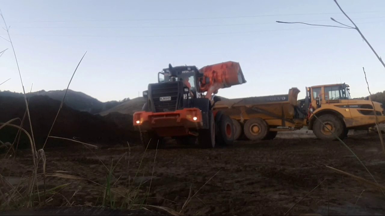 Loading truck using a front end Wheel Loader.. - YouTube