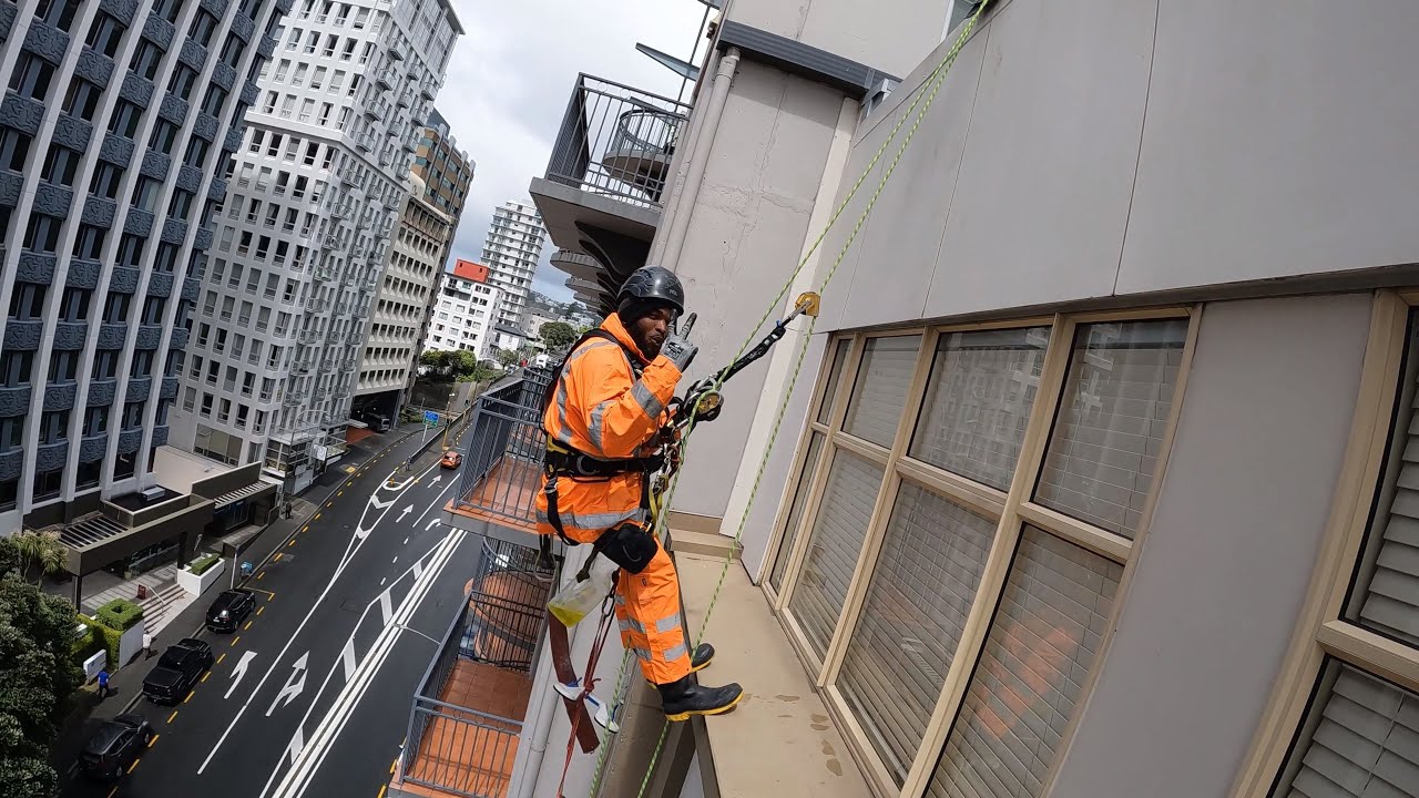 Rope access work building shower. - YouTube
