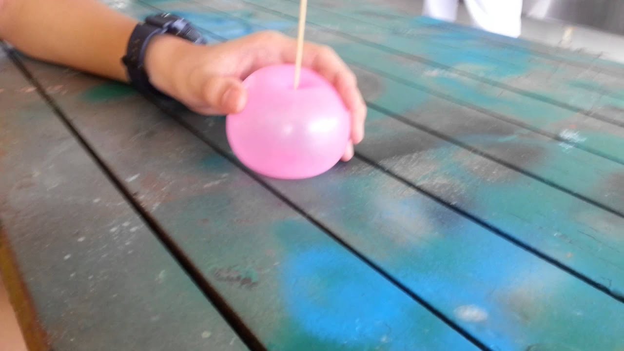 Poking through a balloon - YouTube