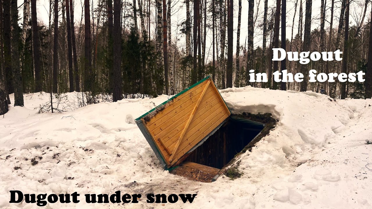 Dugout under snow, winter camping in a warm underground house. Cooked ...