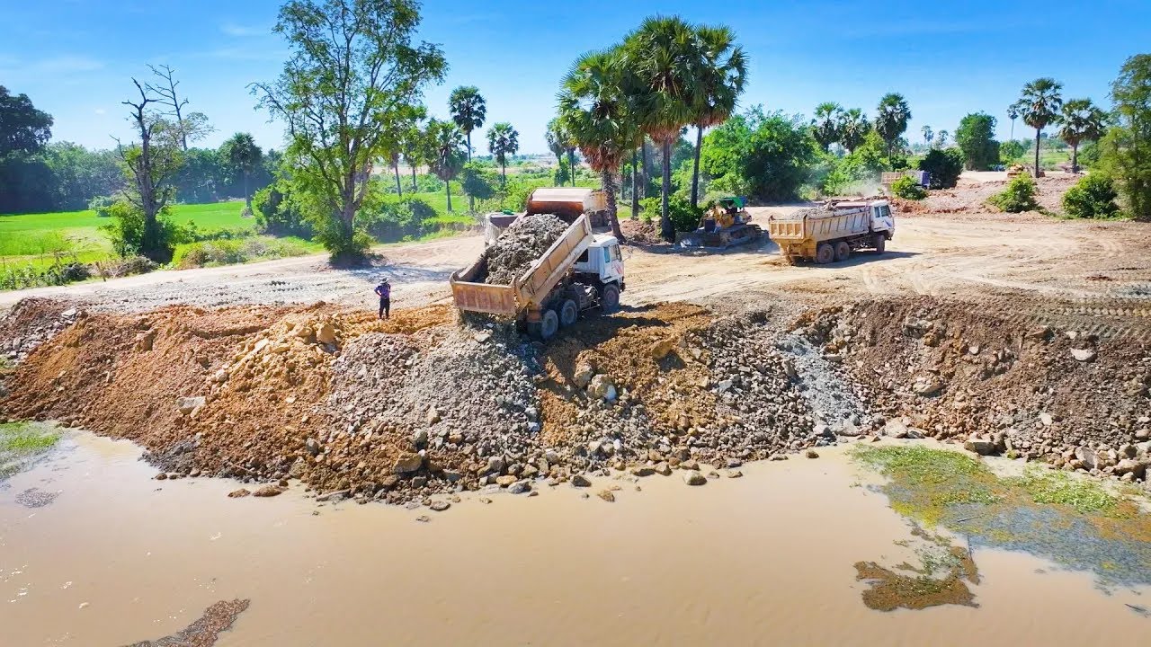 Skilled Operator in Action! D60 Bulldozer Spreads Soil Over Flood Area ...