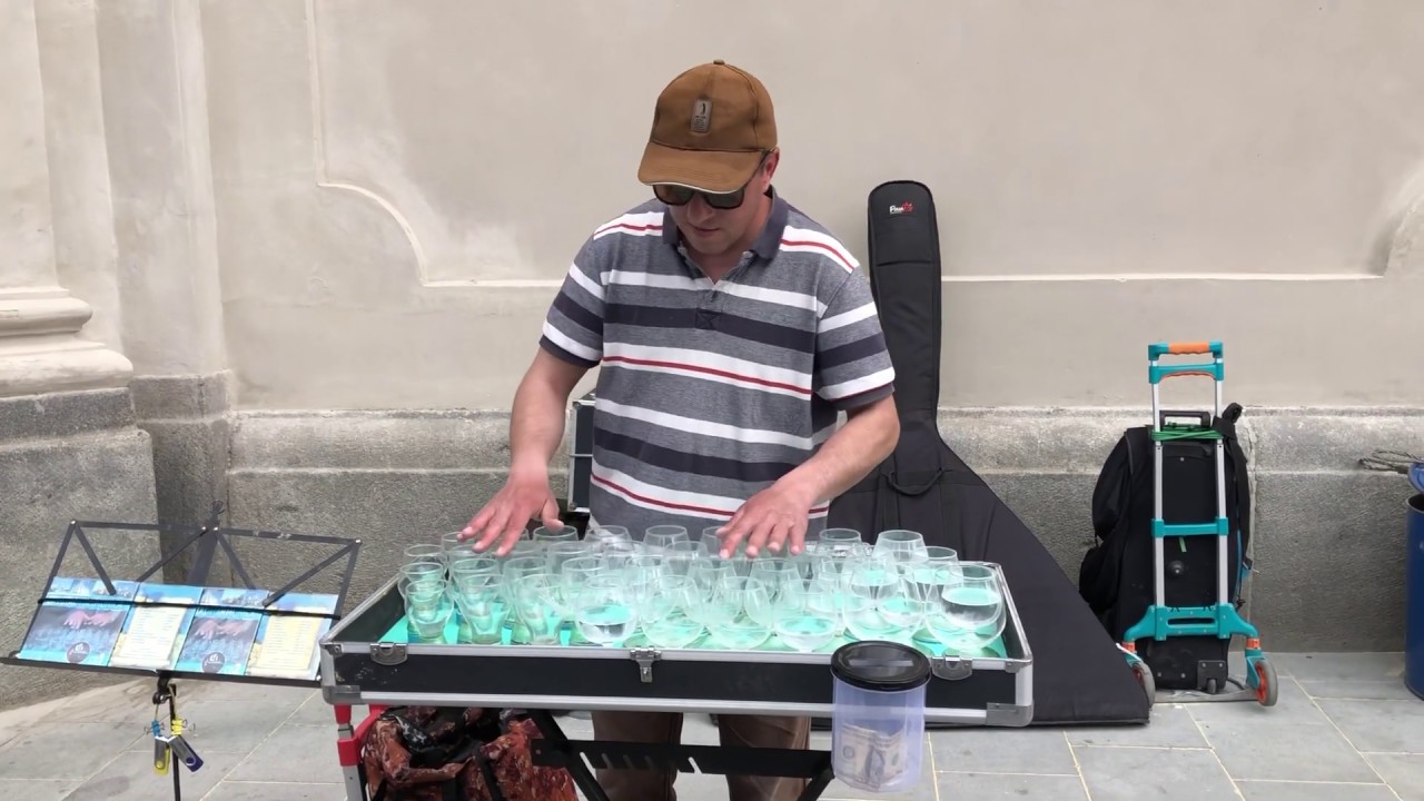 Crystal harmonica - Street artist playing music with crystal glasses ...