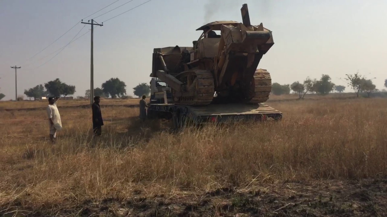 Unloading dozer without ramp - YouTube