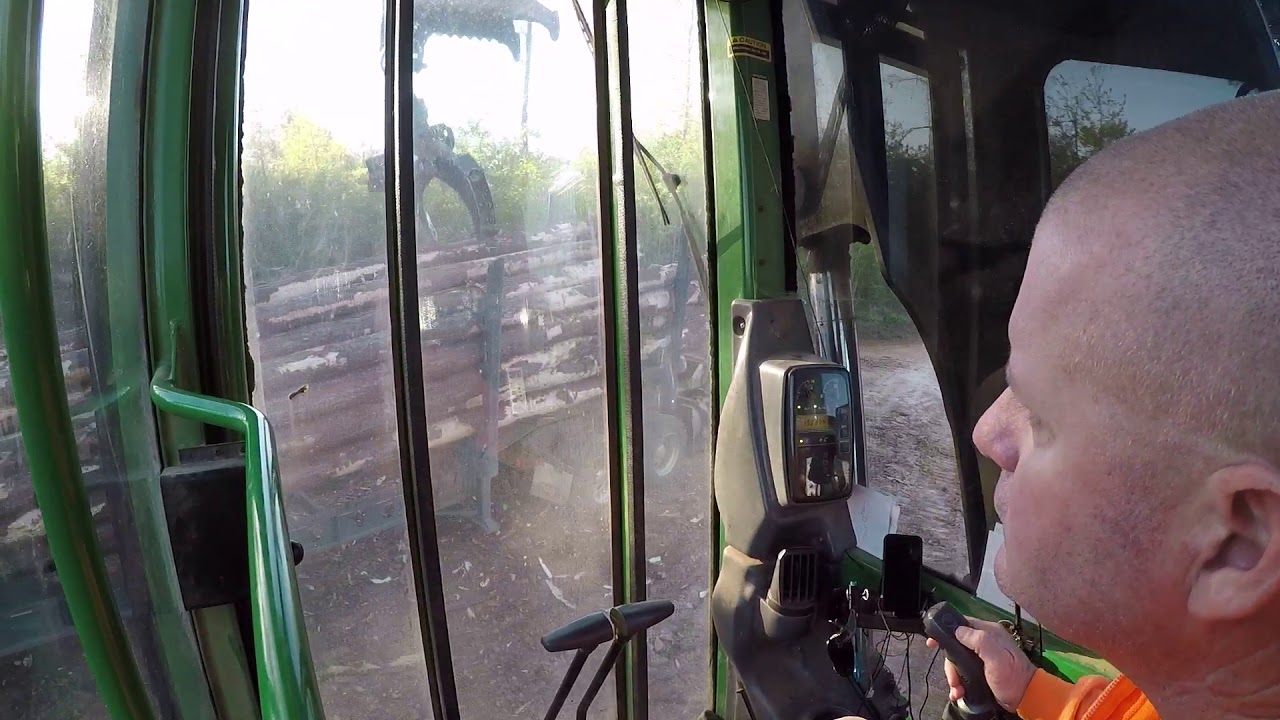 John Deere track loader loading log trucks - YouTube