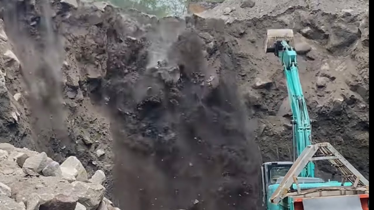 Sand mining. Heavy equipment operator was shocked by the cliff ...