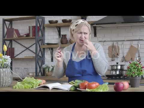 Mature Caucasian Woman Cutting Finger with Kitchen Knife As Cooking Salad at Home | Stock Footag...