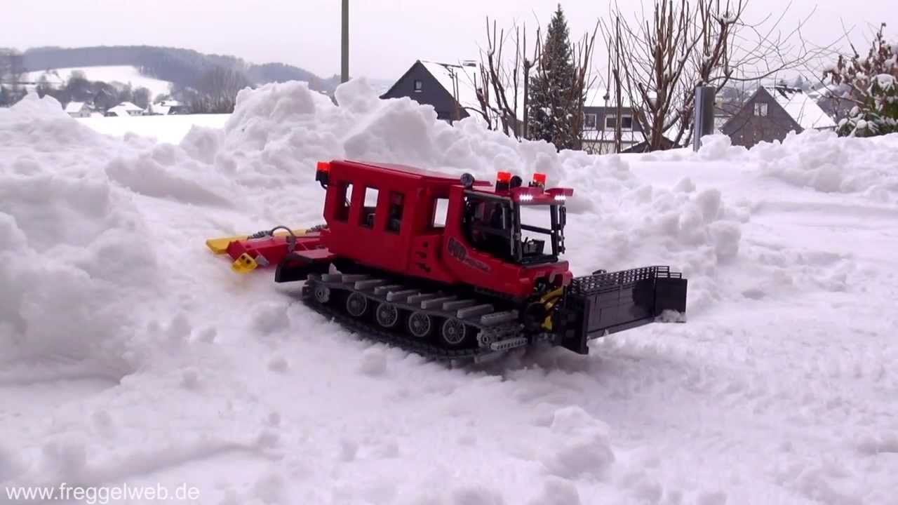 Lego® Technic snow groomer in snow (PistenBully 600 with personnel ...