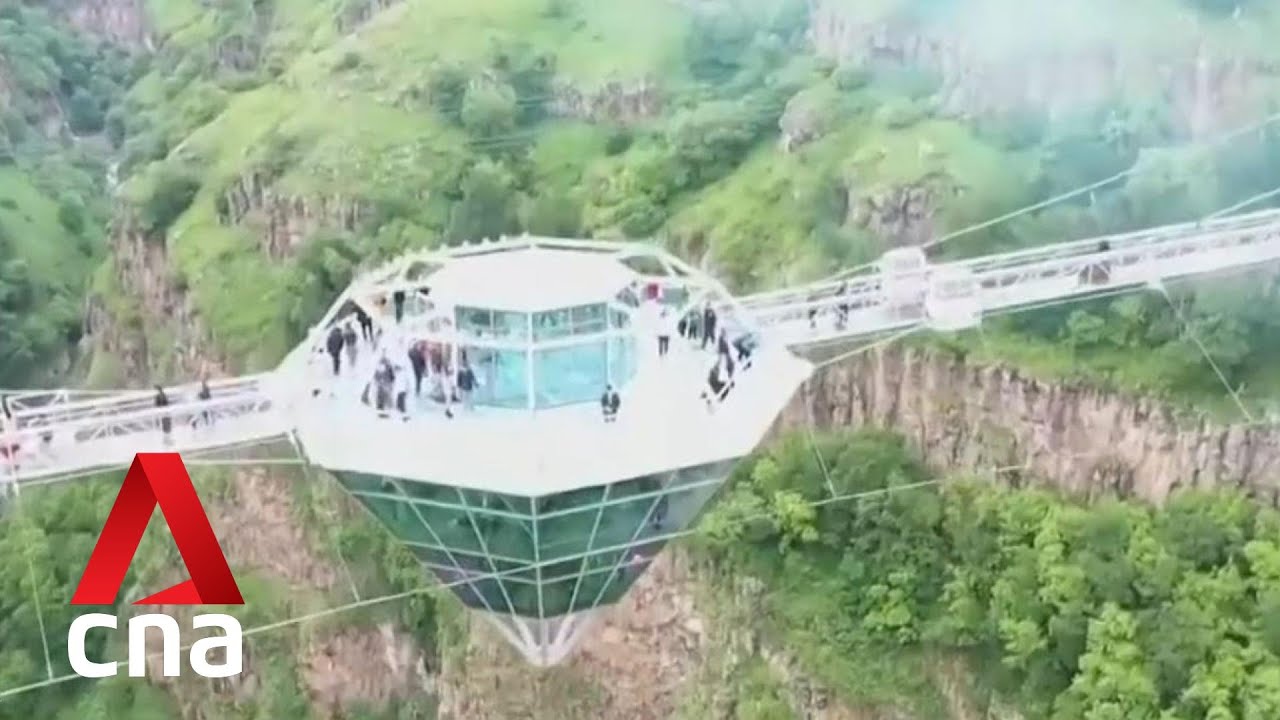 Tourists flock to 240-metre glass bridge across canyon in Georgia - YouTube