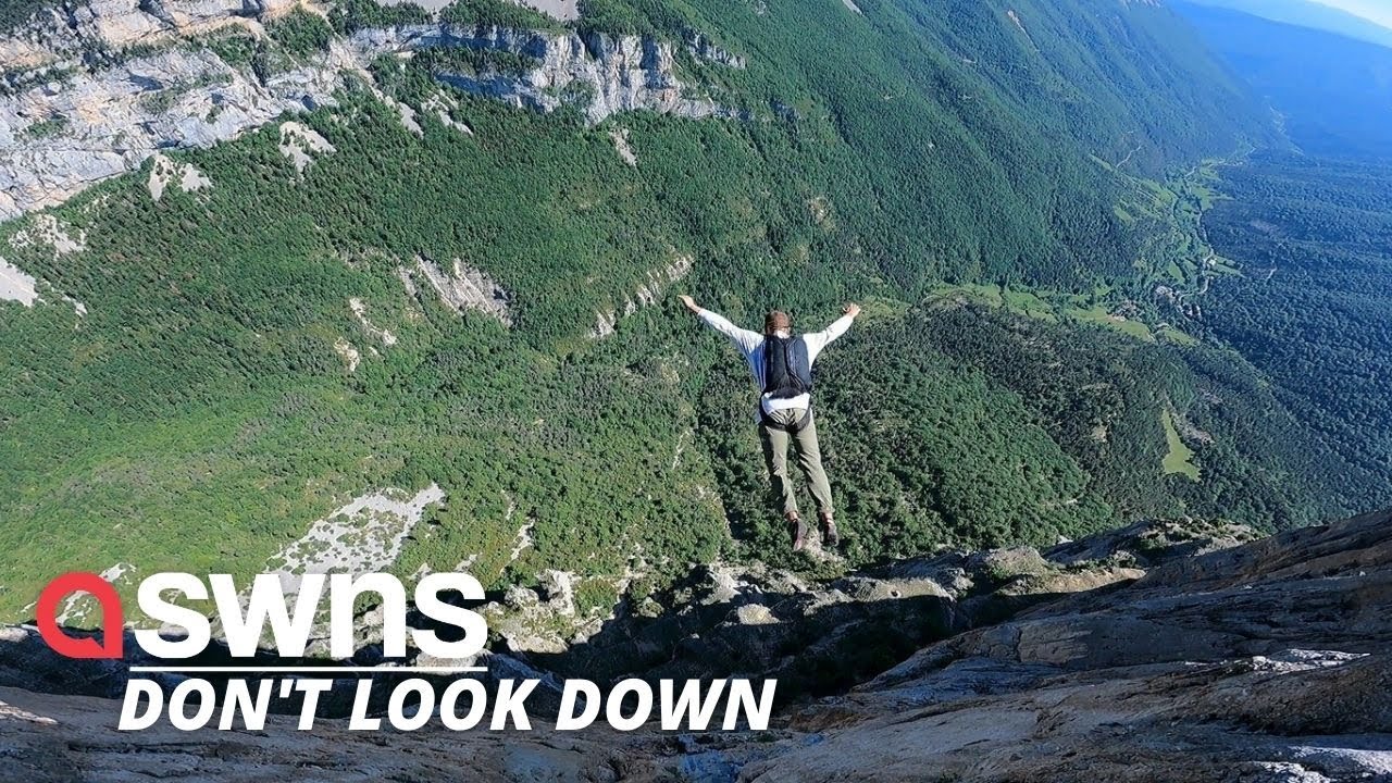 Man base jumps from 500-METER-HIGH CLIFF | SWNS - YouTube