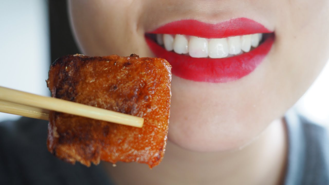 Girl eats Glutinous Rice Cake. Chewed food Warning. Mouth close up ...