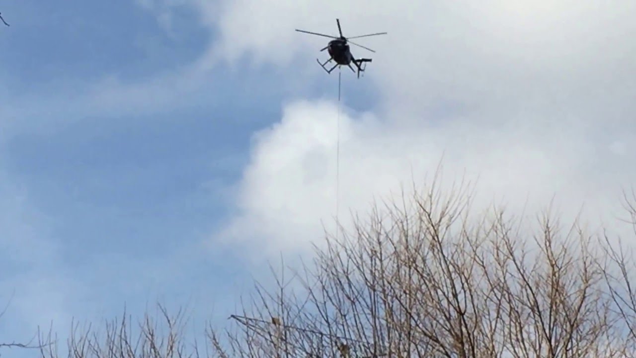 Workers lifted by helicopter for power line maintenance - YouTube