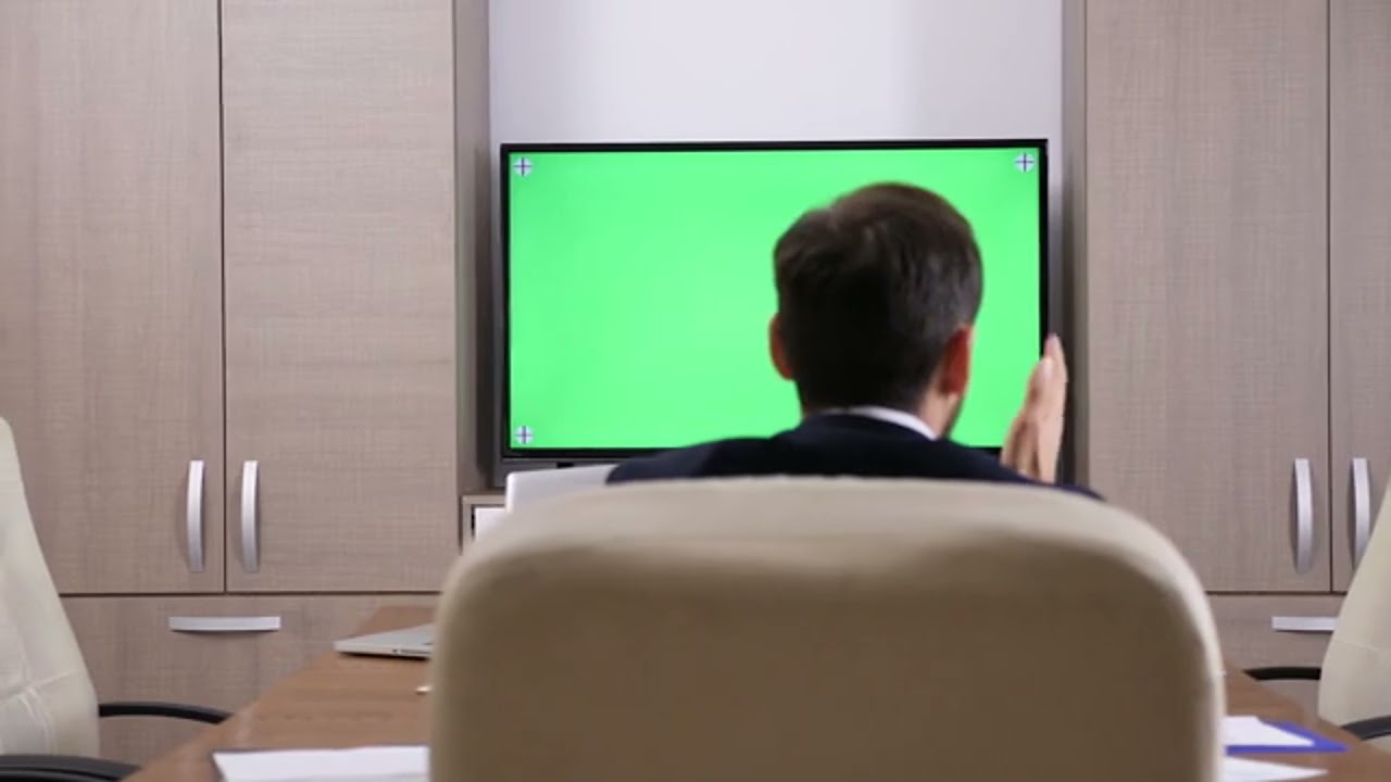 back of businessman head talking to green screen mock up tv dolly ...