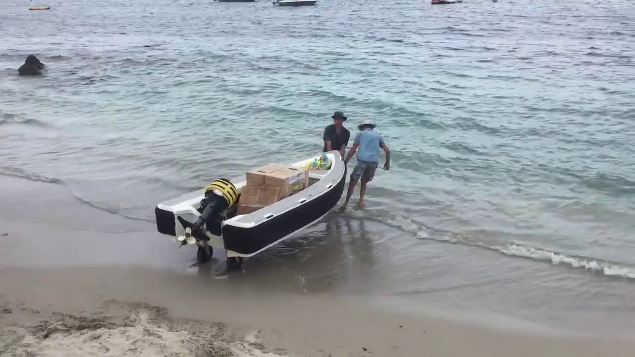 Lauching a tender loaded from the Beach - YouTube