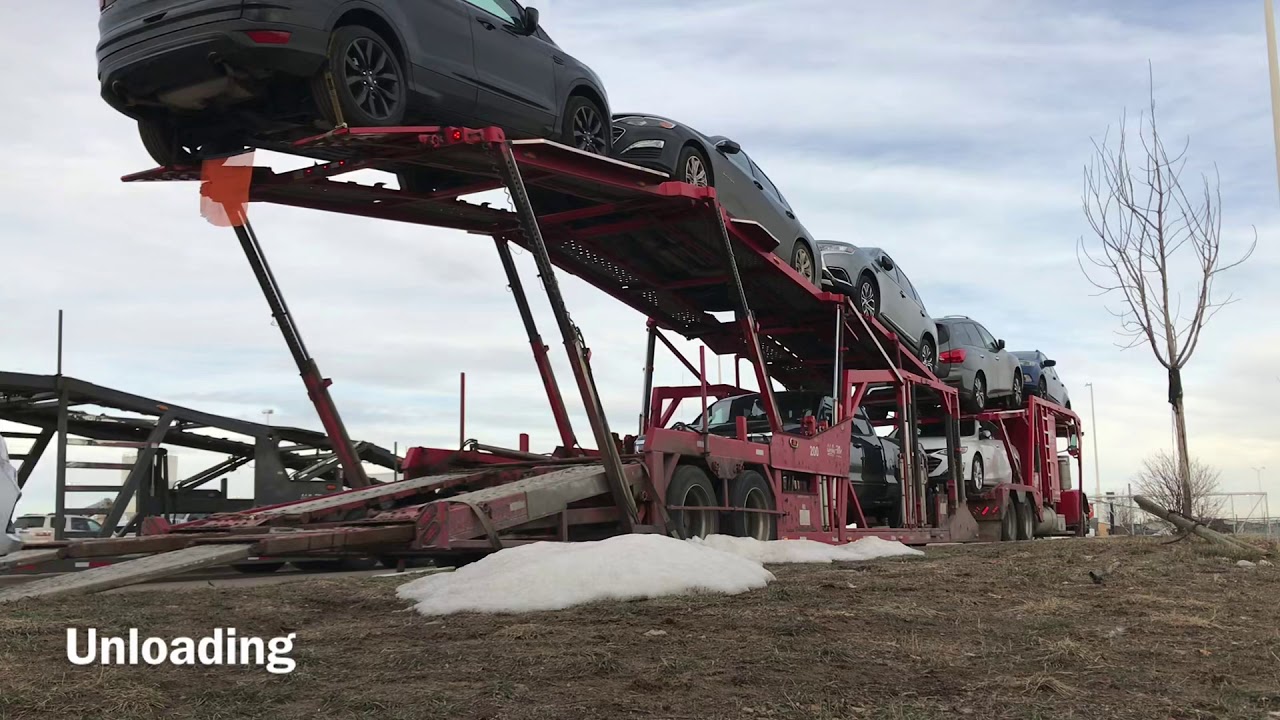 Unloading car from truck - YouTube