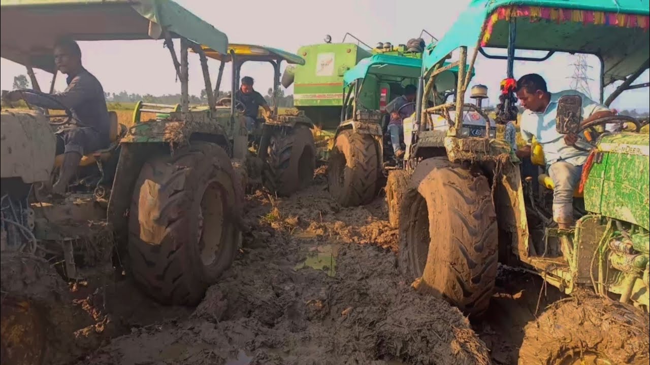 Combine harvester stuck in deep mud pulling other by 11 tractor failed ...