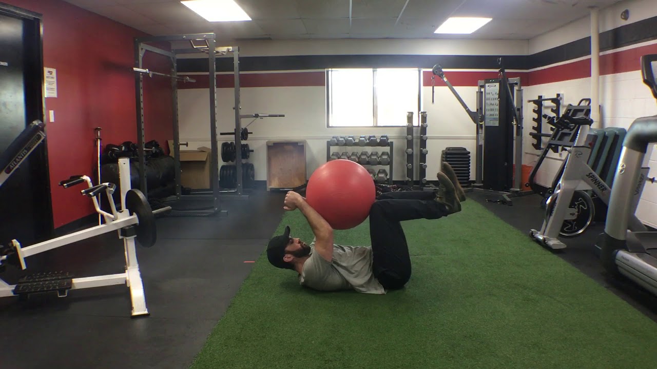 Stability ball crunch hold squeeze + kick out - YouTube