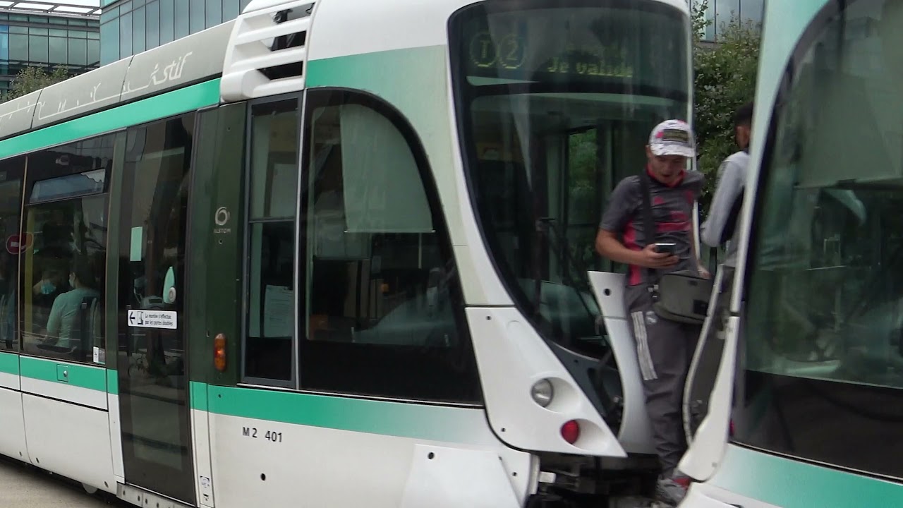 Paris T2 tramway - 2 guys standing on tram coupling of moving tram ...