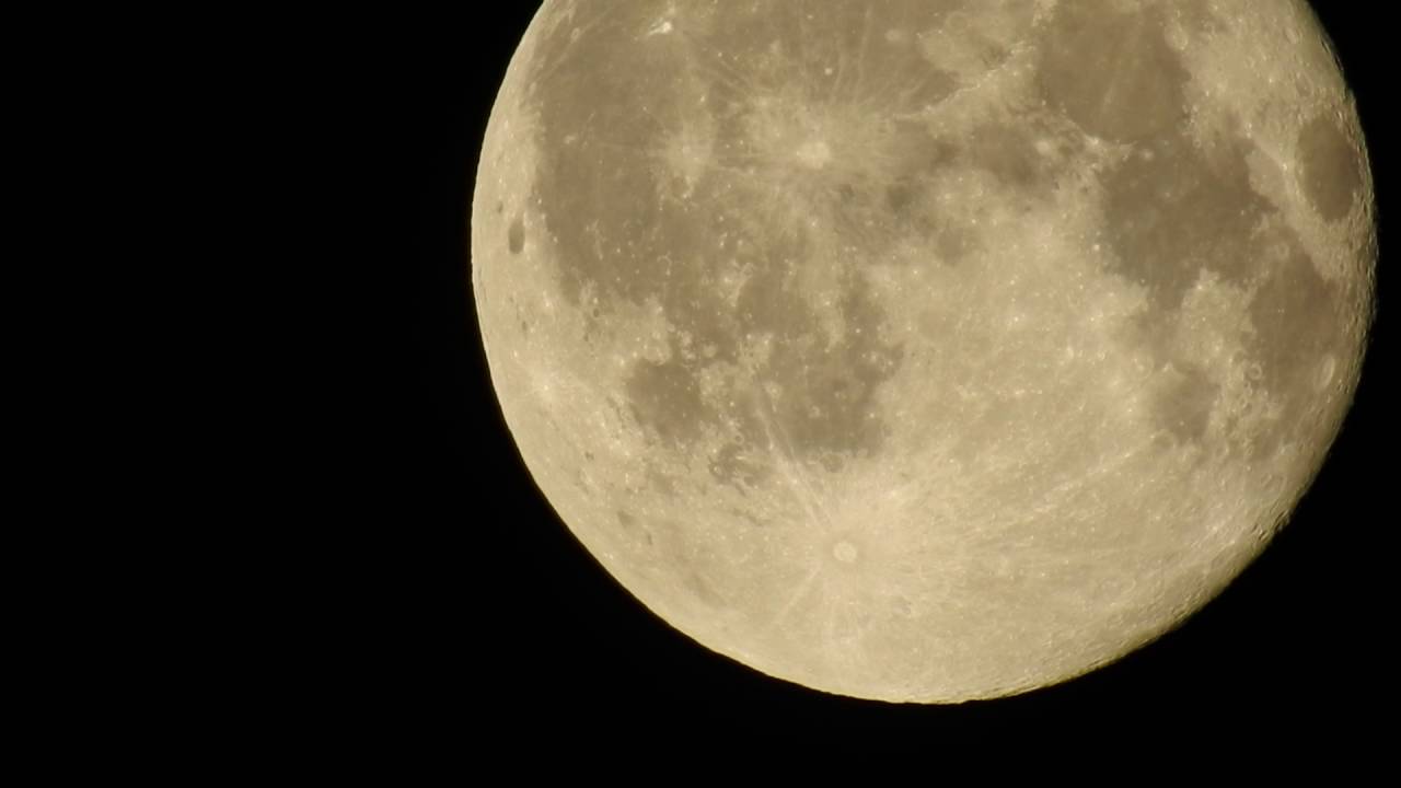 The moon traveling on its path above the earth - YouTube