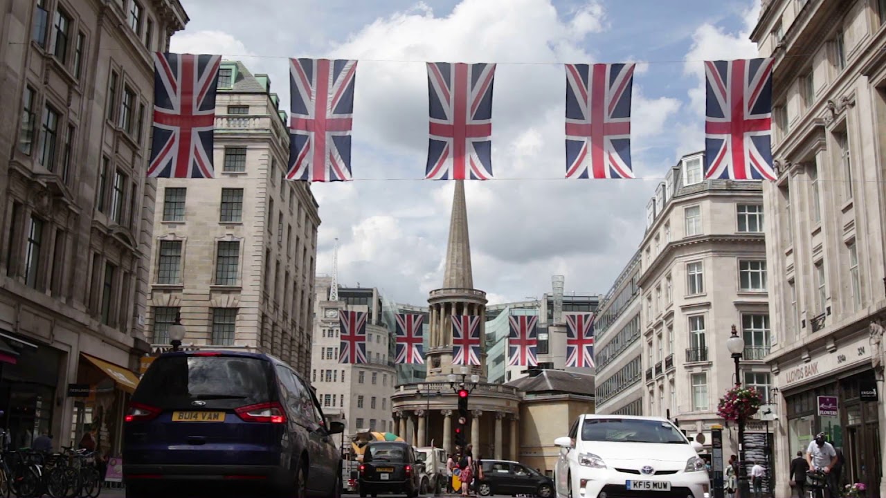 london uk june 28 2016 people and traffic pass under british flags on ...