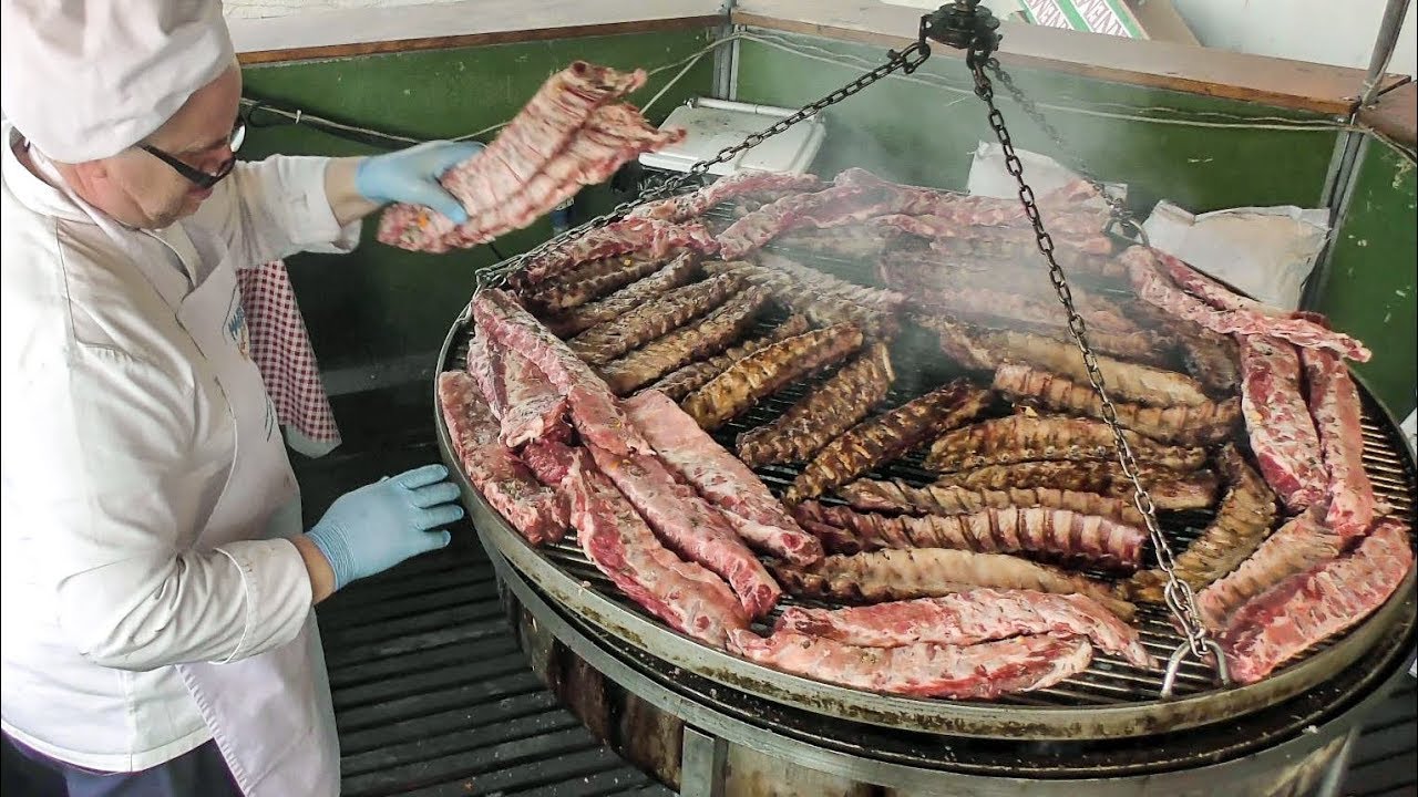 Massive Lot of Beef Ribs on Huge Circular Grills. Italian Street Food ...