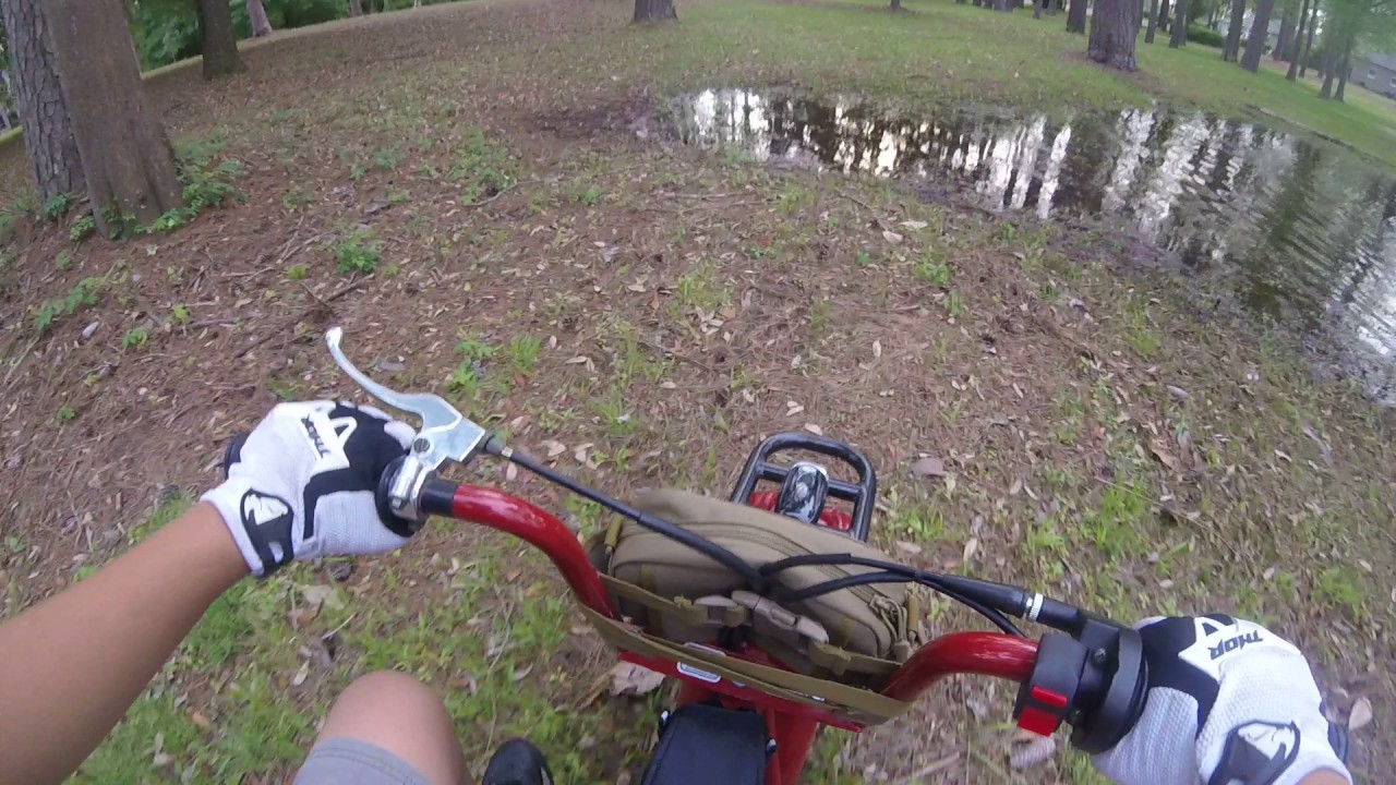 riding mini bike through water and doing wheelies - YouTube