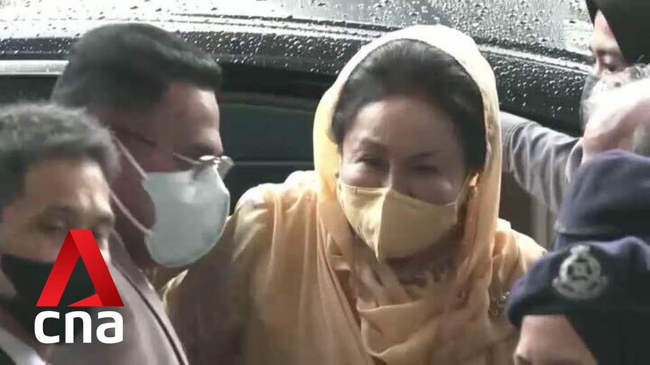 Malaysia’s Rosmah Mansor waves as she leaves the Kuala Lumpur court ...