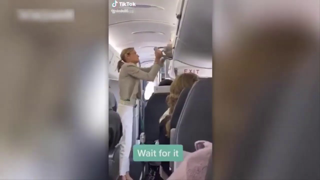 Passengers clap and cheer as woman is kicked off plane for refusing to ...