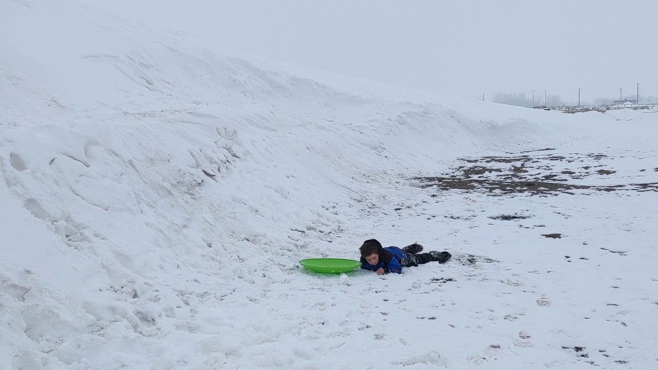 Kid gets wind knocked out of him sledding funny - YouTube