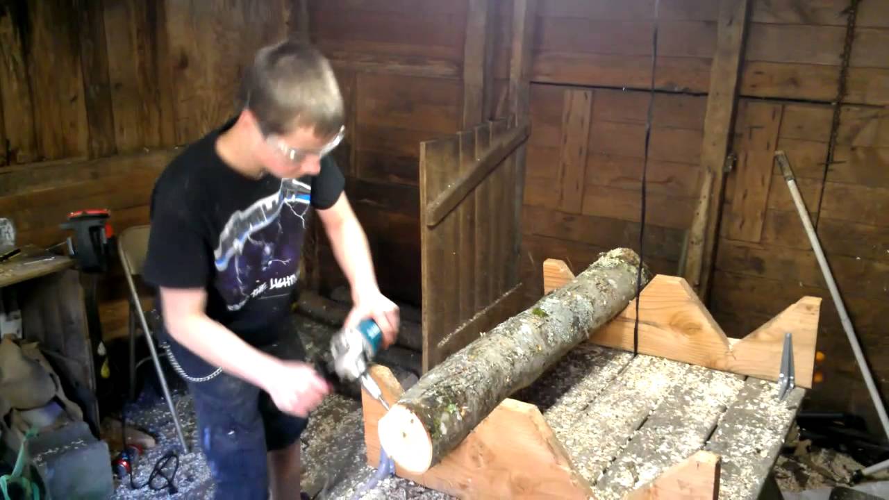 Drilling holes to inoculate a log with new mushrooms - YouTube