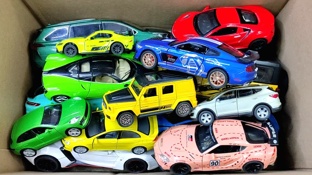 Box full of various miniature cars Peugeot, Volvo, Renault, Hyundai ...