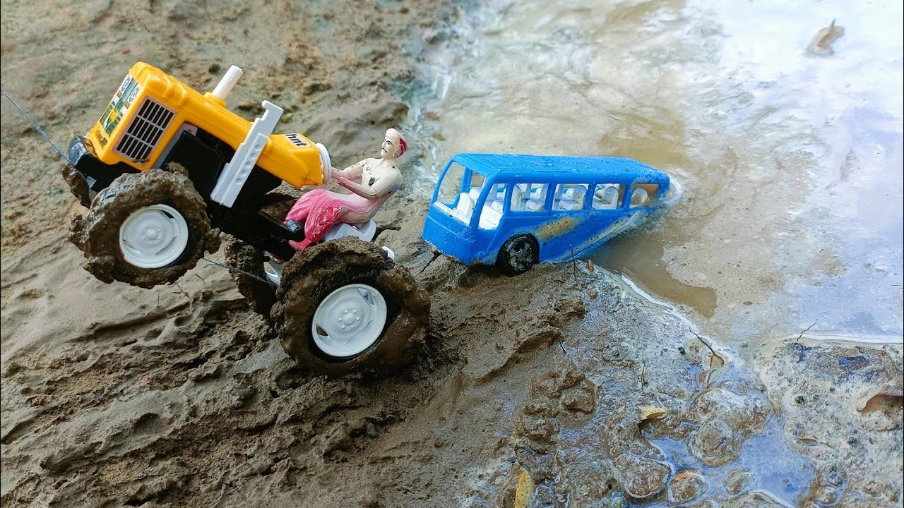Wheels on the bus - stuck in mud pulling out tractor - YouTube