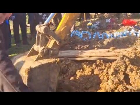 MACHINE DIGGING THE GROUND IN THE CEMETERY - YouTube