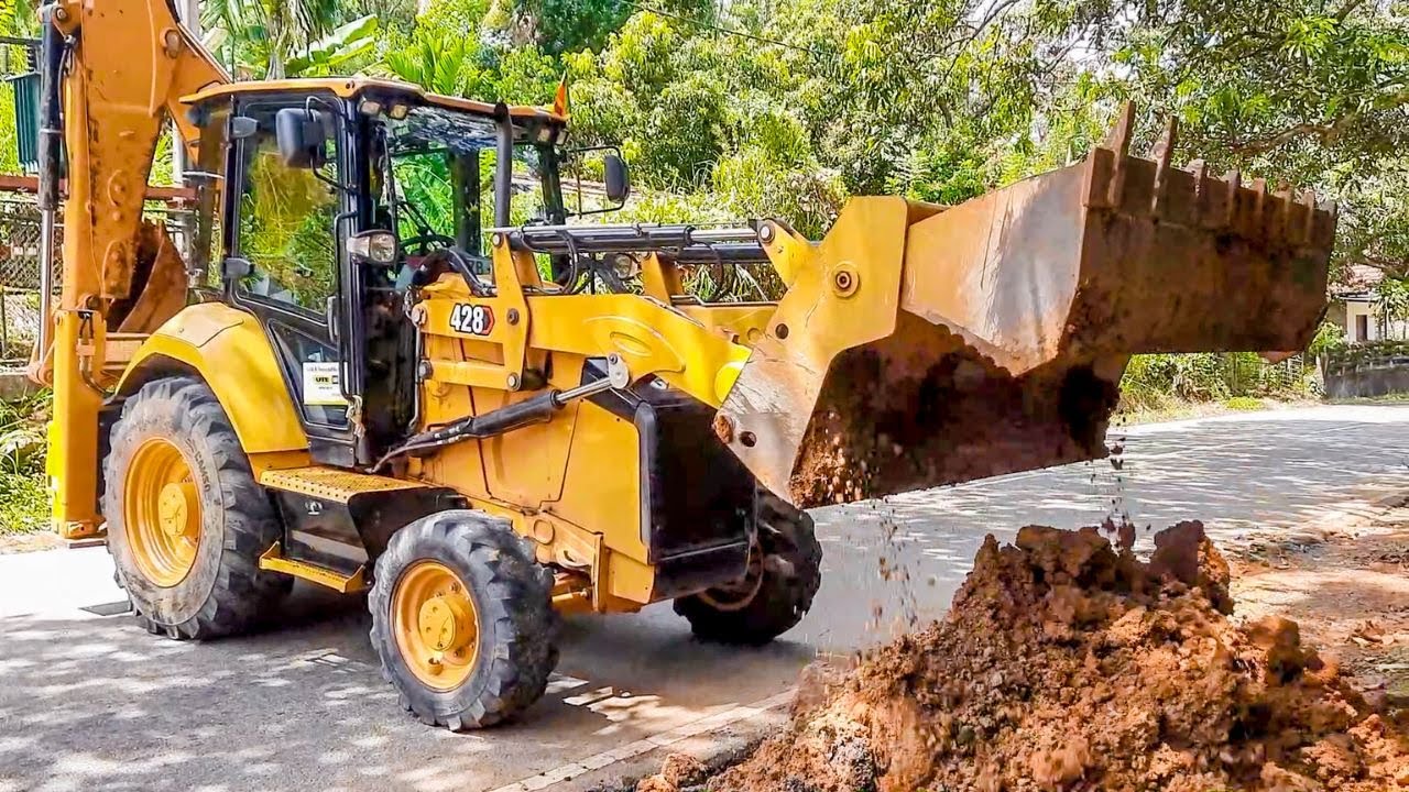 CAT Caterpillar 428 Backhoe Loader Digging Trench in Asphalt Road ...