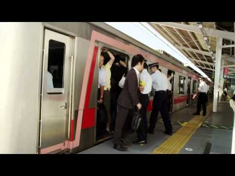 Tokyo Railway Personel Stuffing People Into Overcrowded Commuter Train ...