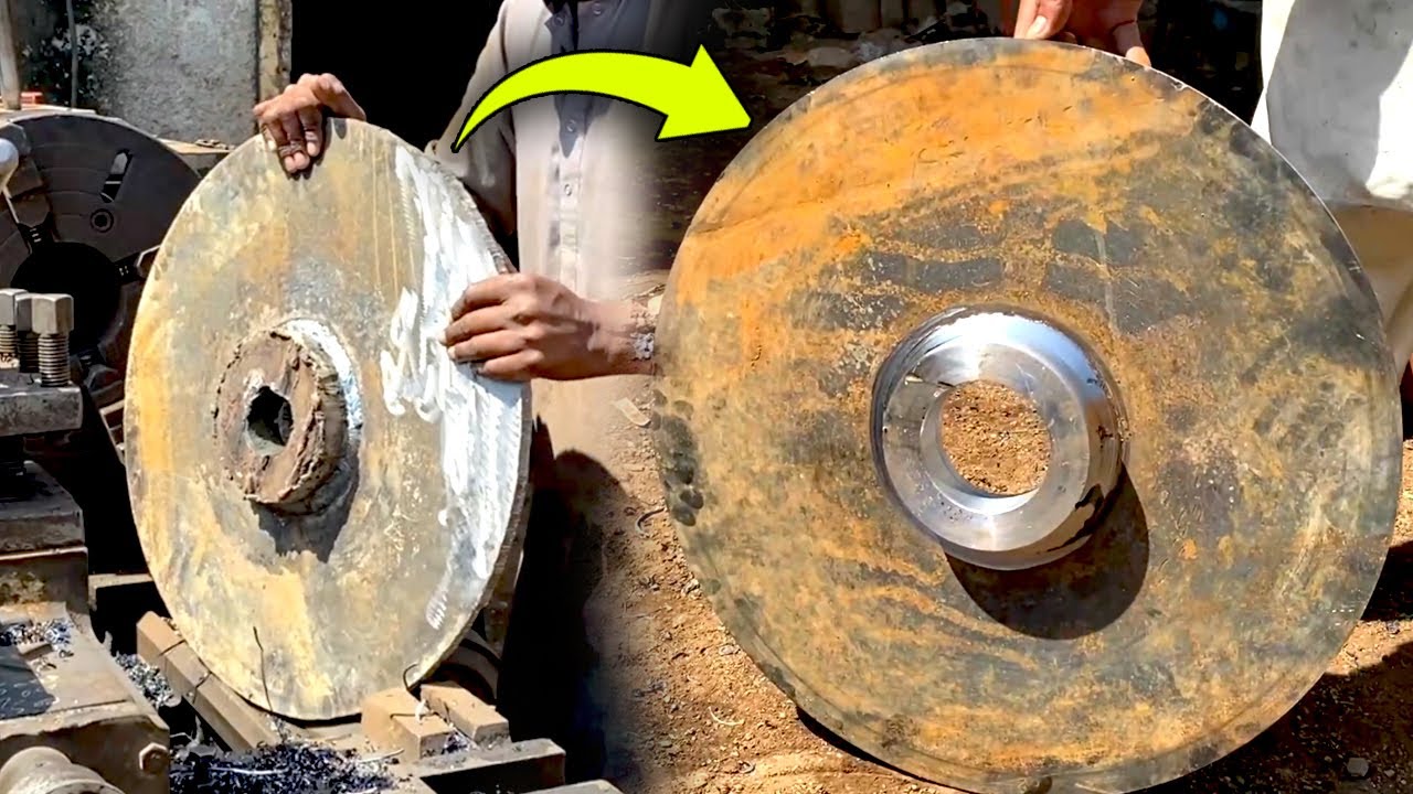 Hard working young man did amazing restoration of stone crusher wheel ...
