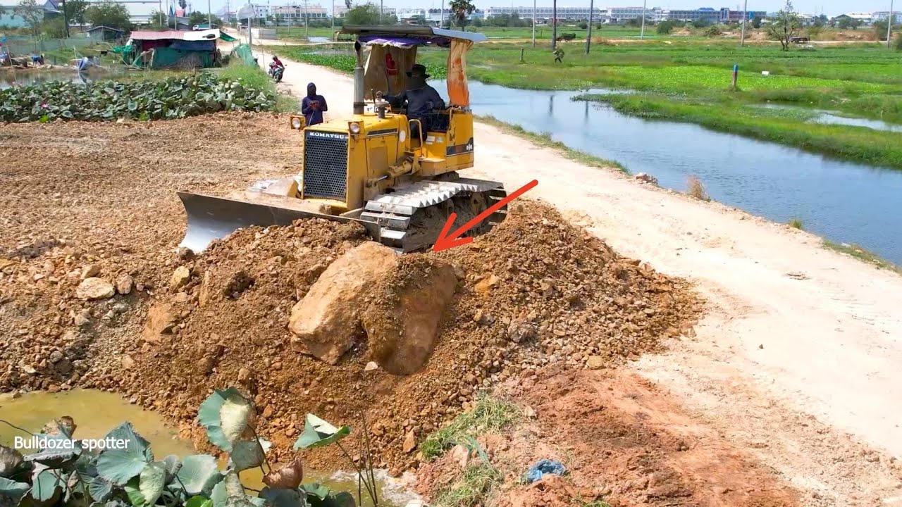 Activity expert bulldozer working push stone landfill with dump truck ...