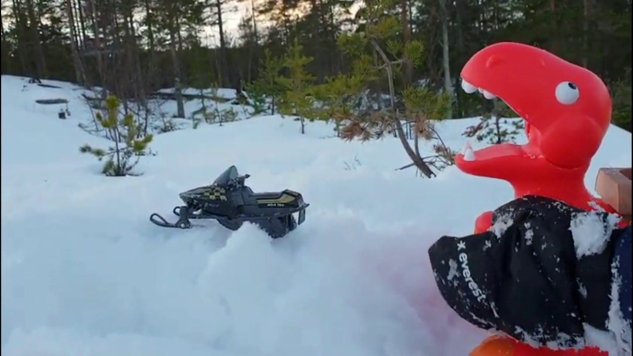 Toy dinosaur eats snow mobile - YouTube
