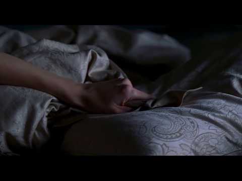 The girl's sleeping posture was pretty but she fell off the bed