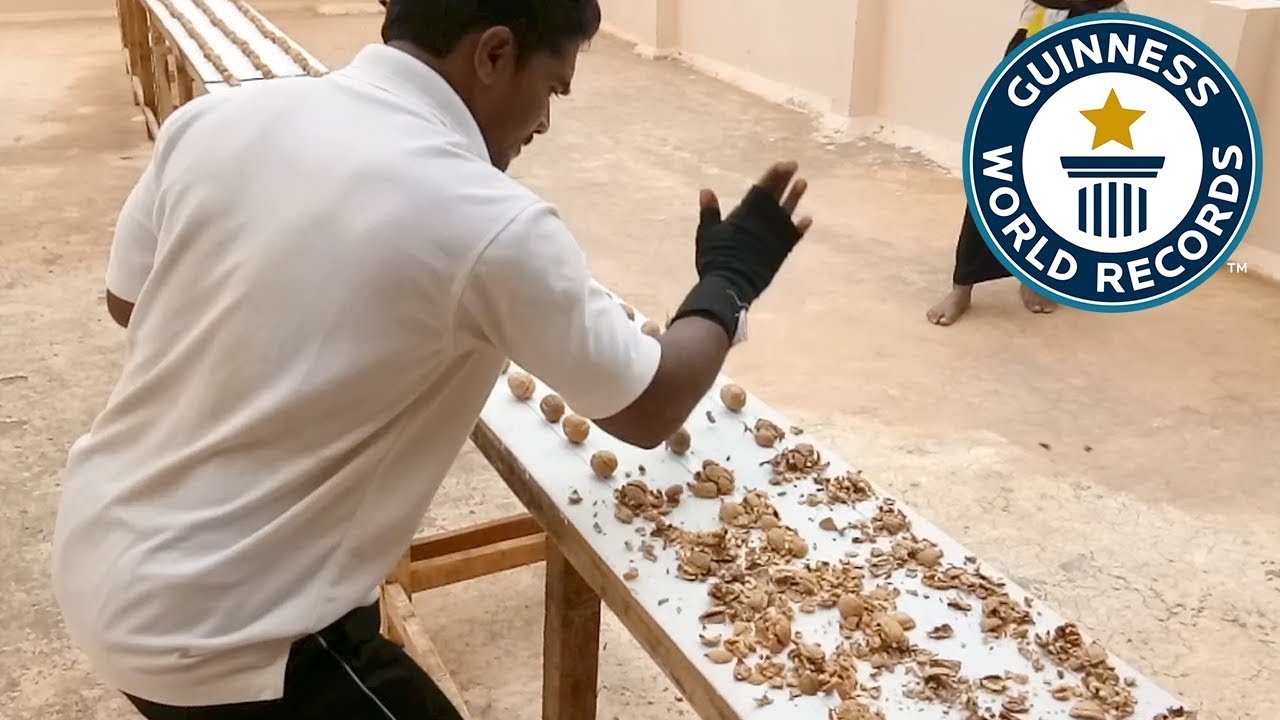 Most walnuts crushed by hand in one minute - Guinness World Records ...