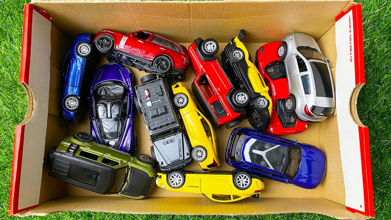 Box full of various miniature cars Pagani, Dodge, Rav4, DHL, Volkswagen ...