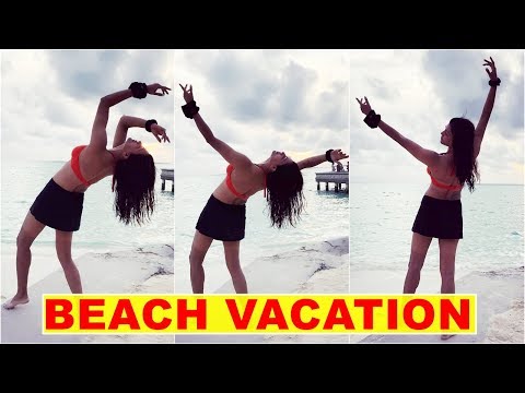 Sushmita Sen flaunts her toned body in a scarlet bikini halter top and mini skirt